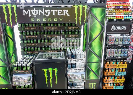 A display of Monster energy drinks cans on the shelves of a grocery ...