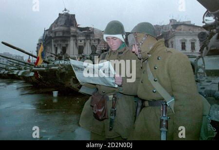 romania after the revolution armed soldiers holding the romanian flag ...