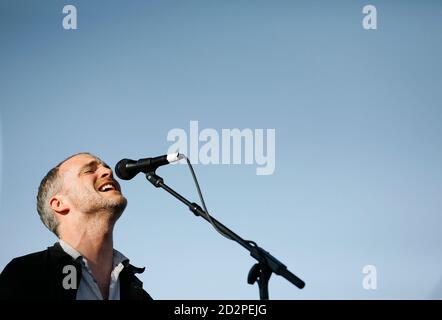 Fran Healy (L) lead singer of Travis talks to bass guitarist Dougie ...
