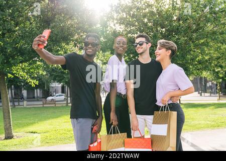 Photo of joyful african american students wearing backpacks holding ...