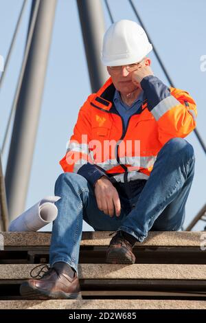 Sad construction worker Stock Photo - Alamy
