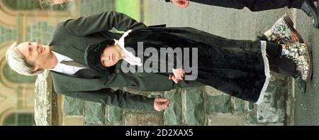 Dr Shaun Russell and daughter Josie walk away from the graveside after ...
