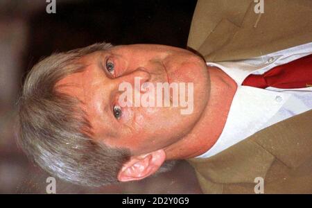 Dr Shaun Russell and daughter Josie walk away from the graveside after ...