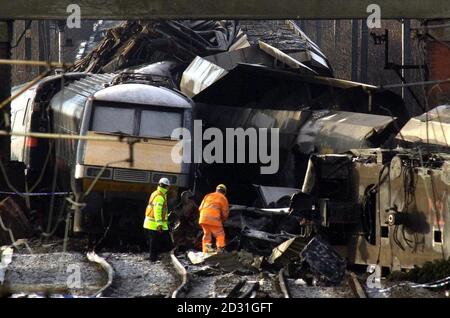 RESCUE WORKERS LIFTING WRECKAGE OF CARRIAGES AT THE SITE OF THE CLAPHAM ...