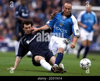 Manchester City's Danny Tiatto slides in on Sporting Lokeren's Patrick ...
