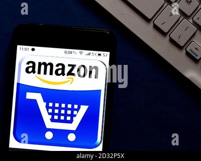 In this photo illustration an Amazon Shopping logo is seen displayed on ...