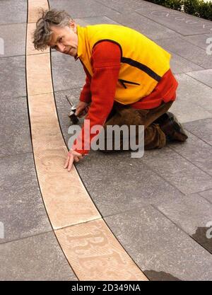 British artist and sculptor Simon Verity demonstrating his stone ...