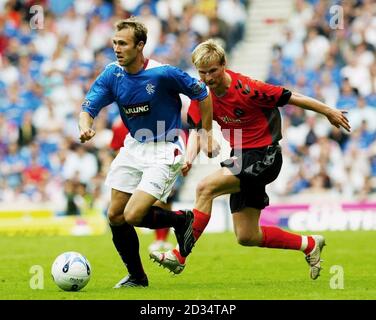 Rangers' Thomas Buffel (R) holds off Hibernian's Stephen Glass during ...