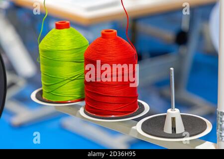 Red and Green Yarn Bobbin Spools at Sewing Machine Stock Photo - Alamy