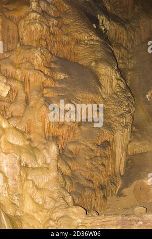 walls inside the cave are covered with stalactites and stalagmites ...