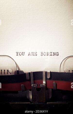 You are boring phrase written with a typewriter Stock Photo - Alamy