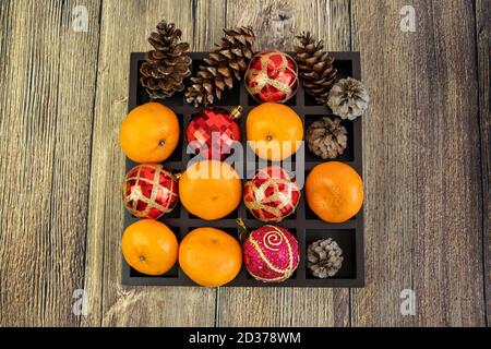 Christmas composition with tangerines, gift boxes, cones on a dark ...