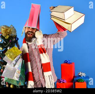Guy with pink packet on head holding shopping bags Stock Photo - Alamy