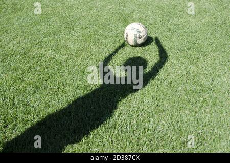 Shadow Playing Football on the Green Grass Stock Photo - Alamy
