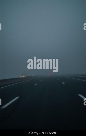 drivers view of fog on a dark motorway Stock Photo - Alamy