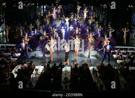 Paris Lido Feature. Cabaret dancers perform on stage at a night club in ...