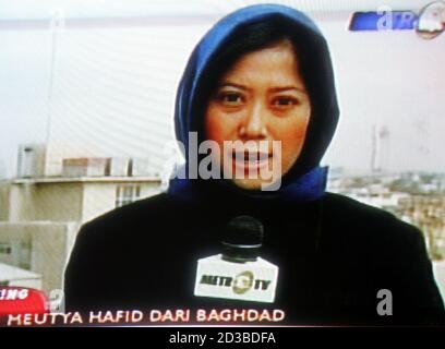 Female Middle Eastern television reporter does here stand up report ...