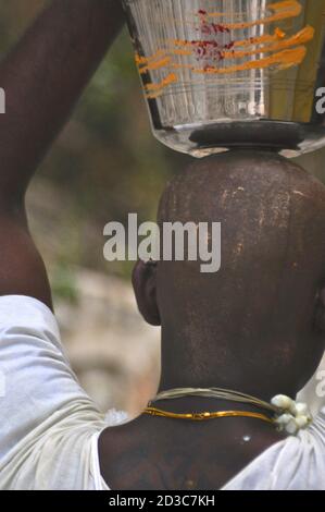 A young Hindu devotee has her head shaved as a sacrifice at the ...