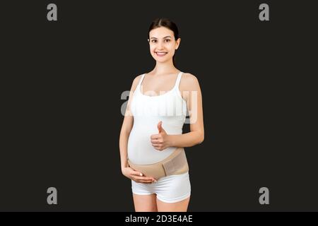 Young pregnant woman wearing band aid for vaccine injection smiling ...