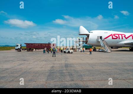 Livestock in wooden boxes being offloaded by a high-loader from a Jumbo ...