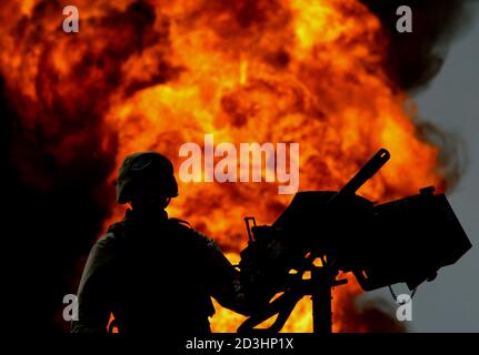 Iraq War March 2003 A machine gunner on board an RAF Puma helicopter ...