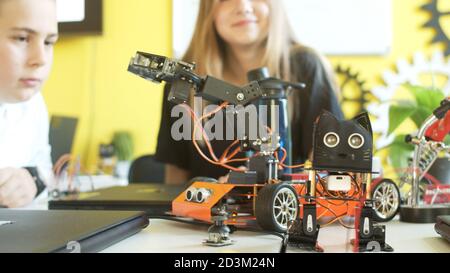 Crop teenager playing with modern robot in class Stock Photo - Alamy