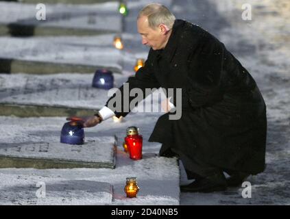 Russian President Vladimir Putin lights a candle during a visit to St ...