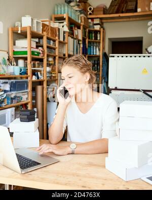 Young female graphic designer with color palettes in office Stock Photo ...