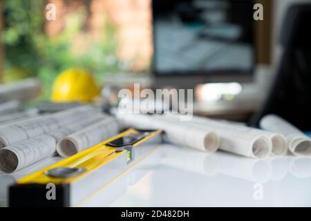 Contractor office. Tool kit of the contractor: yellow hardhat, libella ...