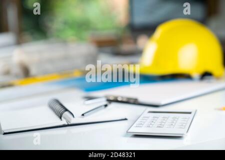 Contractor office. Tool kit of the contractor: yellow hardhat, libella ...