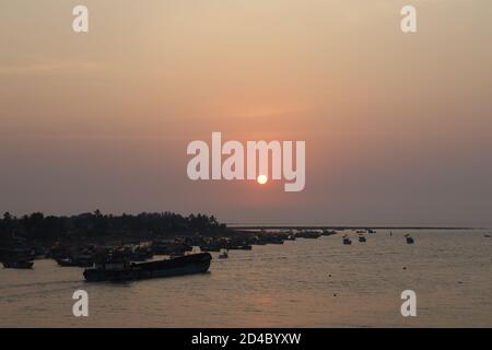 The sunset at a lovely beach crowded by peoples Stock Photo - Alamy