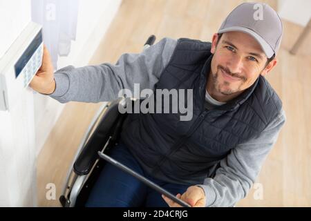 disabled electrician installing alarm system Stock Photo - Alamy
