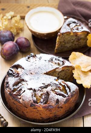 Rustic plum cake on wooden background with plums around Stock Photo - Alamy