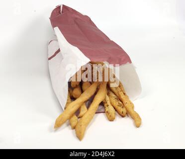 Closeup shot of fresh breadsticks in a paper package isolated on a ...