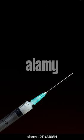 Closed syringe isolated on black background Stock Photo - Alamy