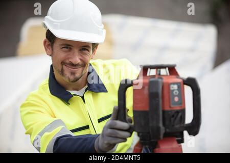 geometer measuring foundation at construction site Stock Photo - Alamy