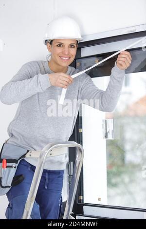 Young Woman Installing Windows Stock Photo - Alamy