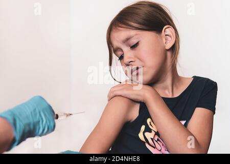 girl is crying afraid of the injection vaccination. Fear of injections ...