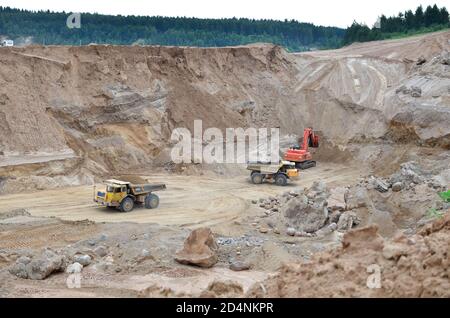 Excavator developing the sand on the opencast and loading it to the ...