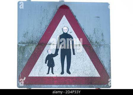 Road sign of adult and child holding hands warns of no pedestrian path ...