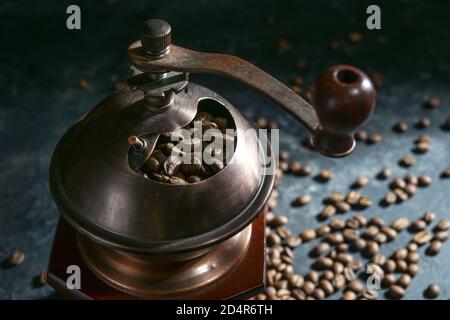 coffee grinder with beans on vintage wood close up Stock Photo - Alamy