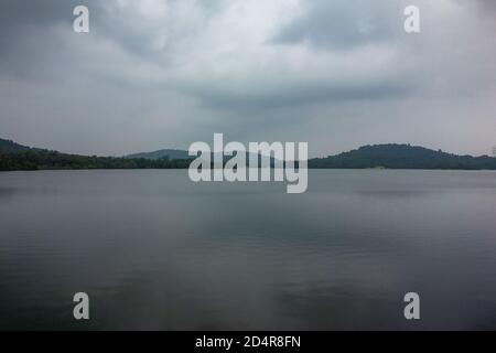 Pleasant view of Amthane Dam reservoir on an overcast day during ...