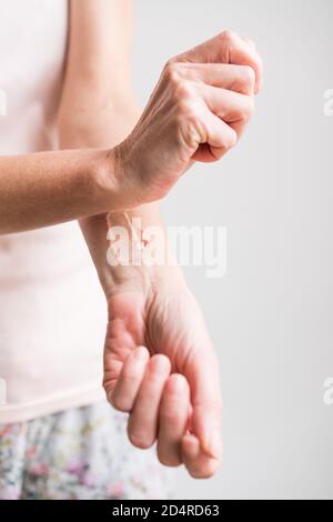 Woman applying an estrogen gel on her hands for a Hormone Replacement ...