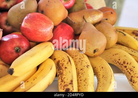 A variety of ripe fruit, apples, pears, grapes, and yellow, red and ...