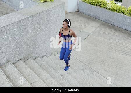 young african american sportswoman running on stadium near 2020 ...