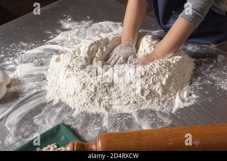 Closeup shot of a baker mixing the flour with eggs to bake a cake Stock ...
