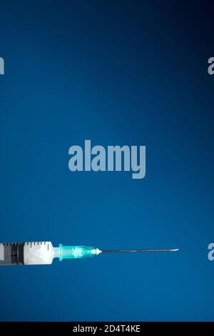 Syringe cannula with blue background, close-up Stock Photo - Alamy