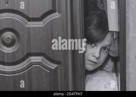 Mad scary girl in cupboard at dark night. Horror background with child ...