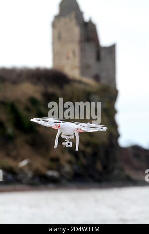 Portrait of drone operator flying aircraft quadcopter near the forest ...