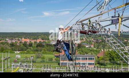 Overhead lineman & industrial climbers, working on a pylon in Bavaria ...